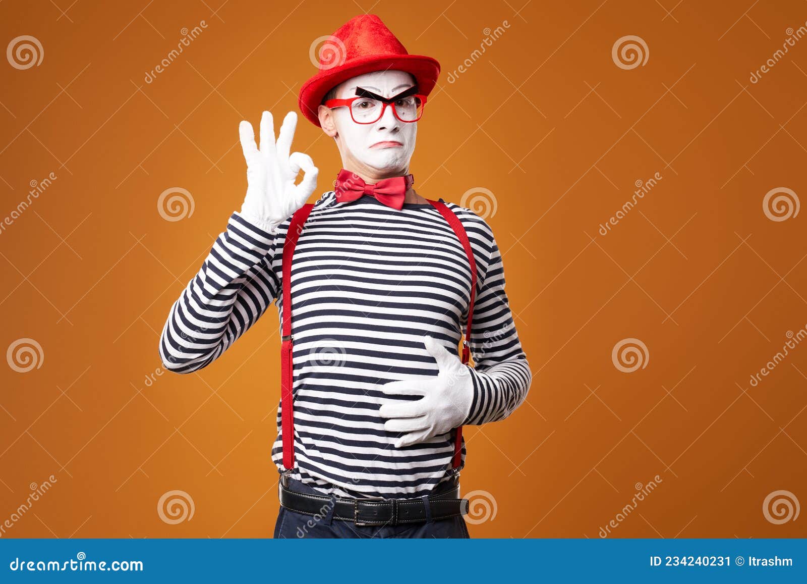 Serious Mime in Red Hat and Vest on Orange Background Stock Image ...