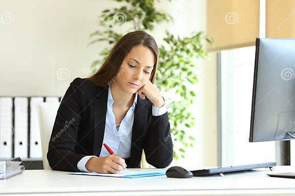 Serious Office Worker Writing on Document Stock Photo - Image of ...