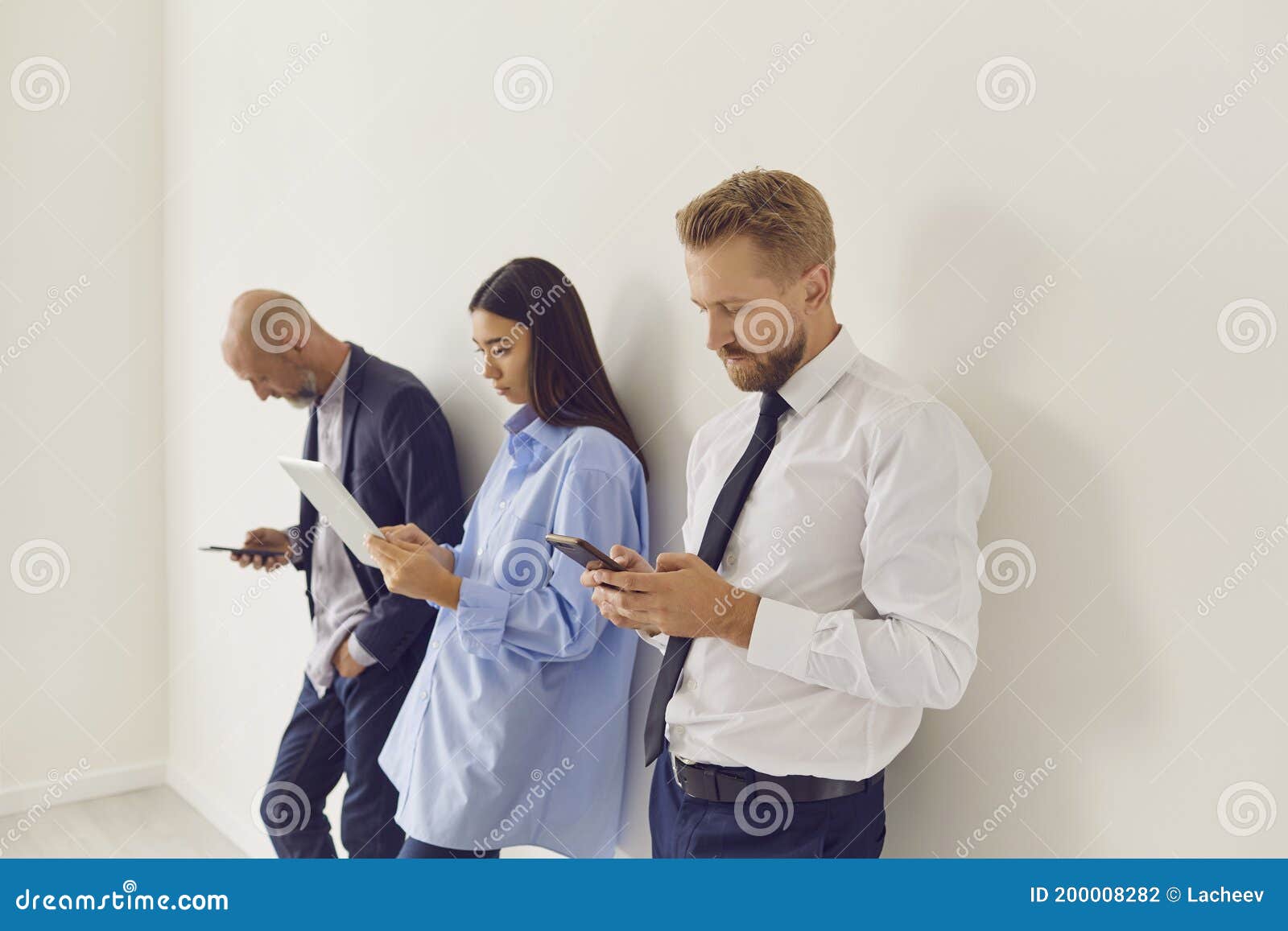 Serious Office Workers of Different Ages Using Modern Gadgets during ...