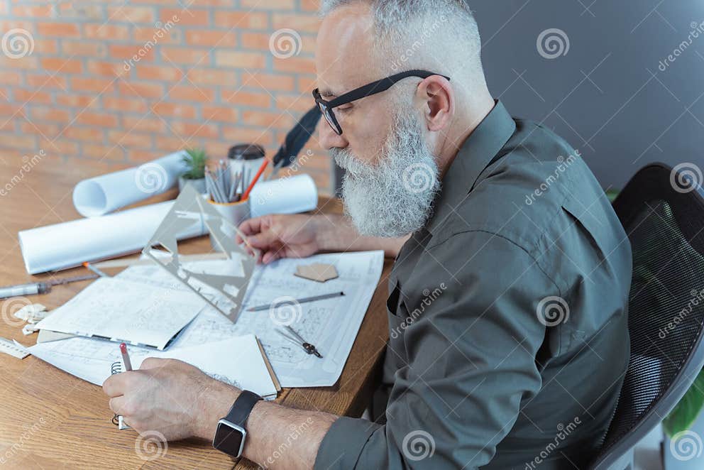 Serious Old Engineer is Correcting Building Plan Stock Image - Image of ...