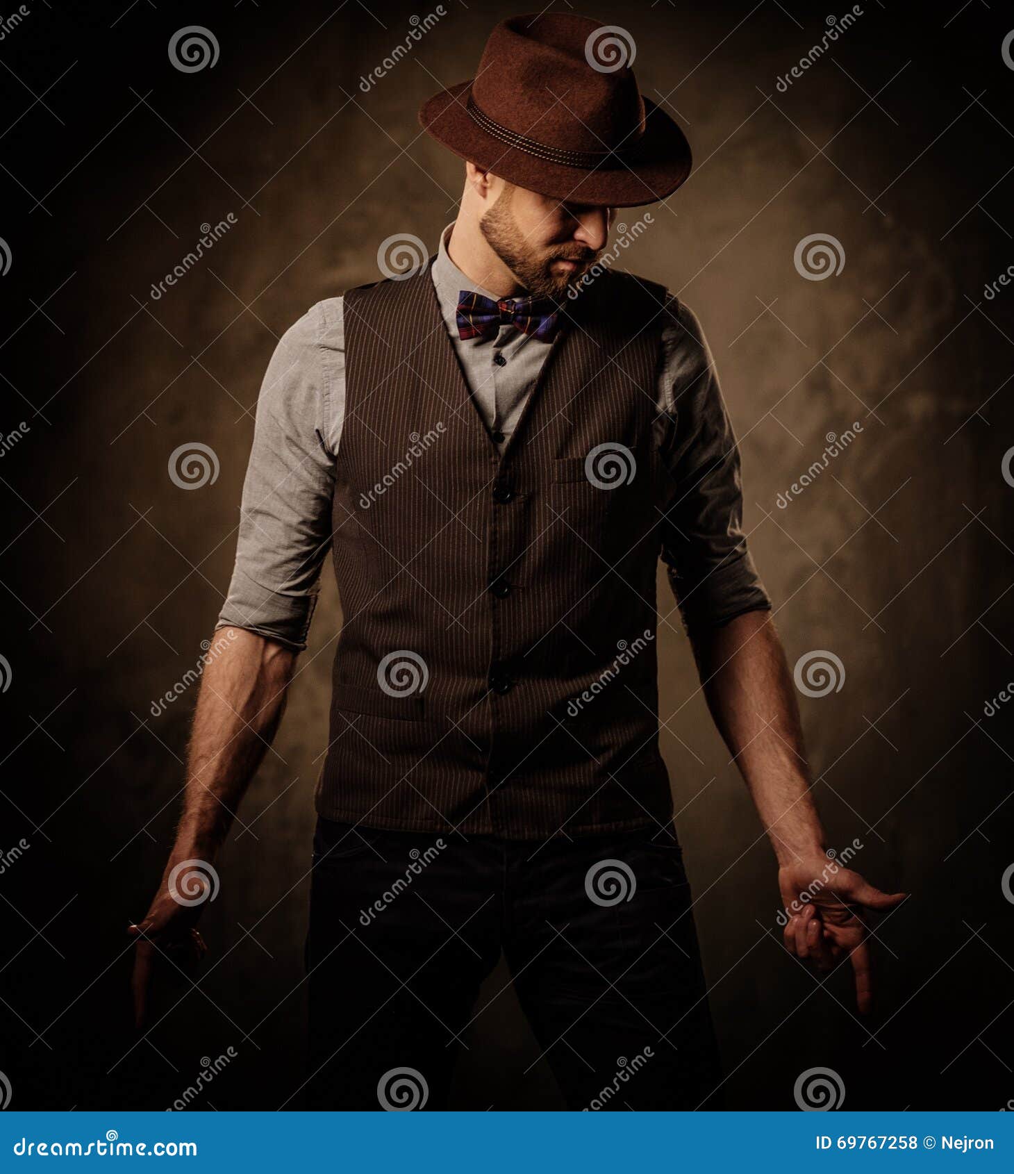 Serious Old-fashioned Man with Hat Posing on Dark Background. Stock ...