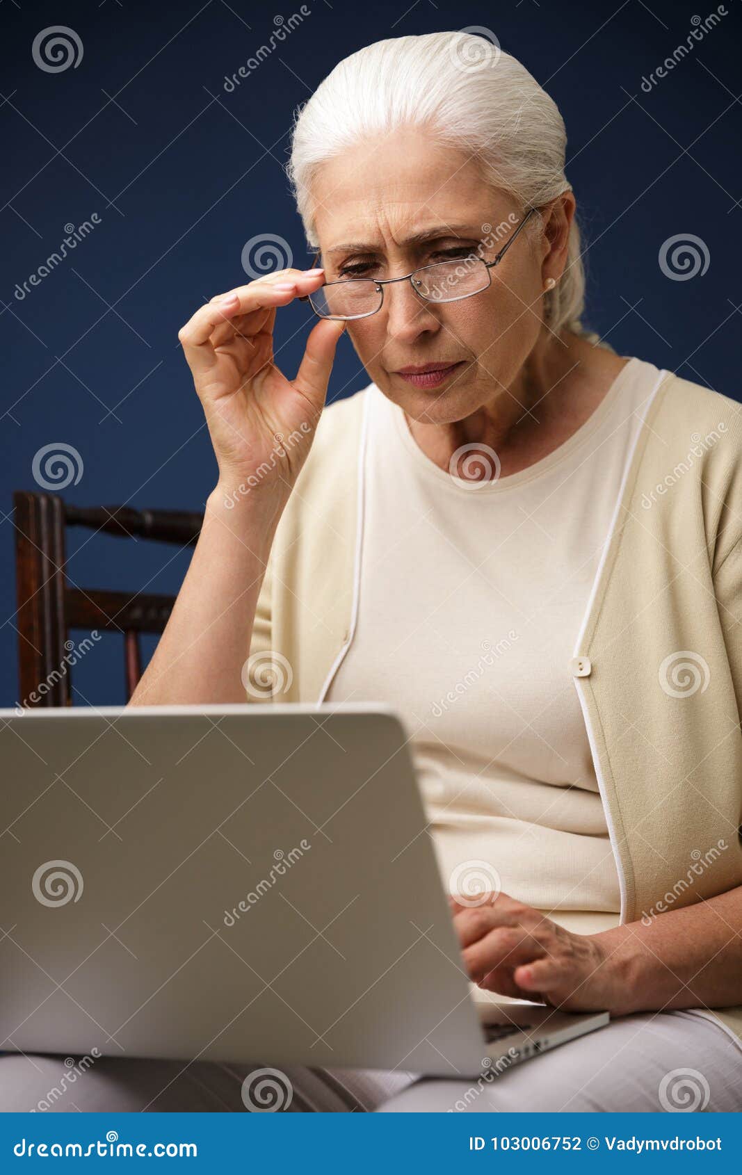Serious Old Woman Using Laptop Computer. Looking Aside. Stock Photo ...