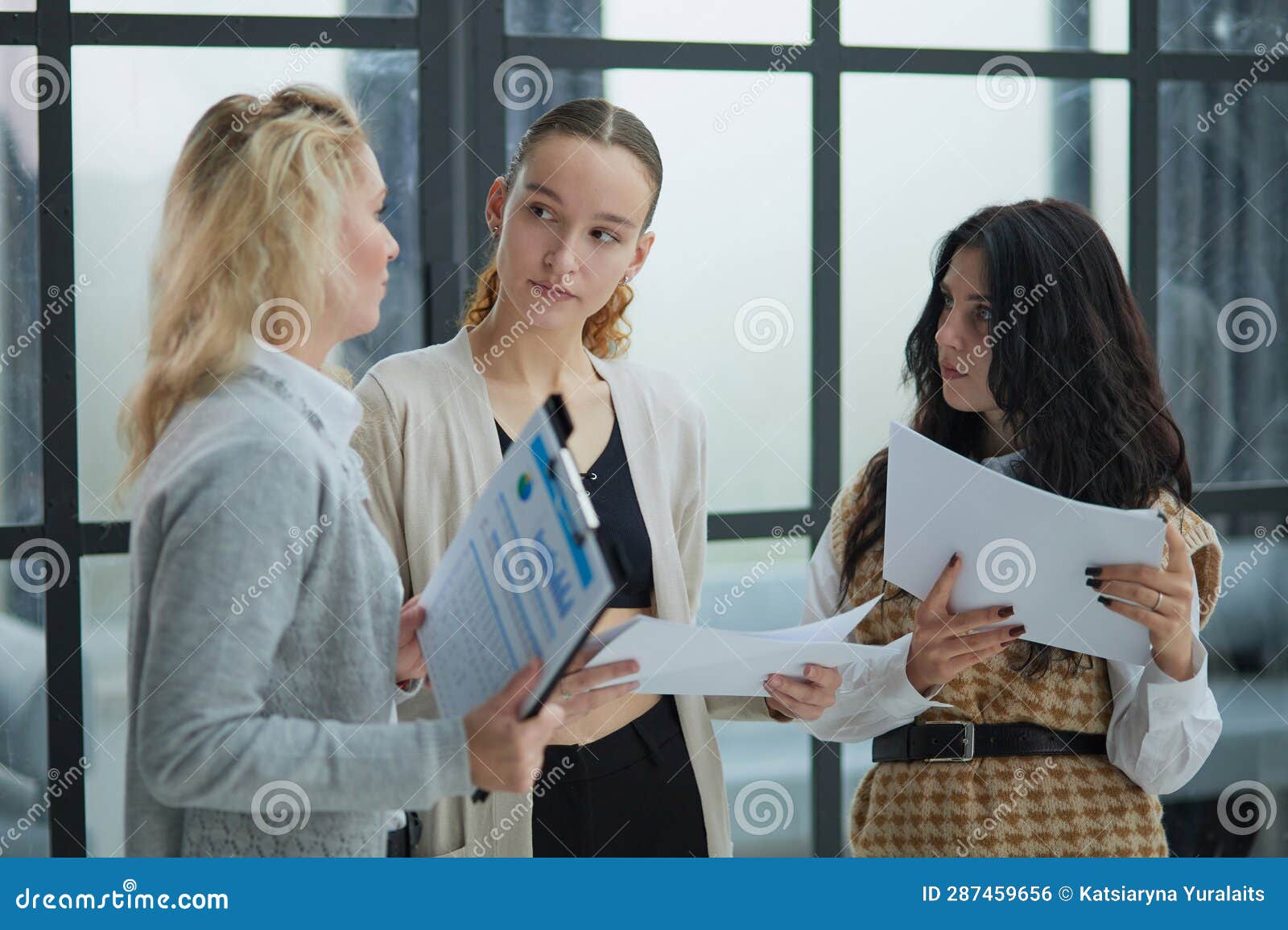 Serious People are Holding a Folder and Writing on Papers while ...