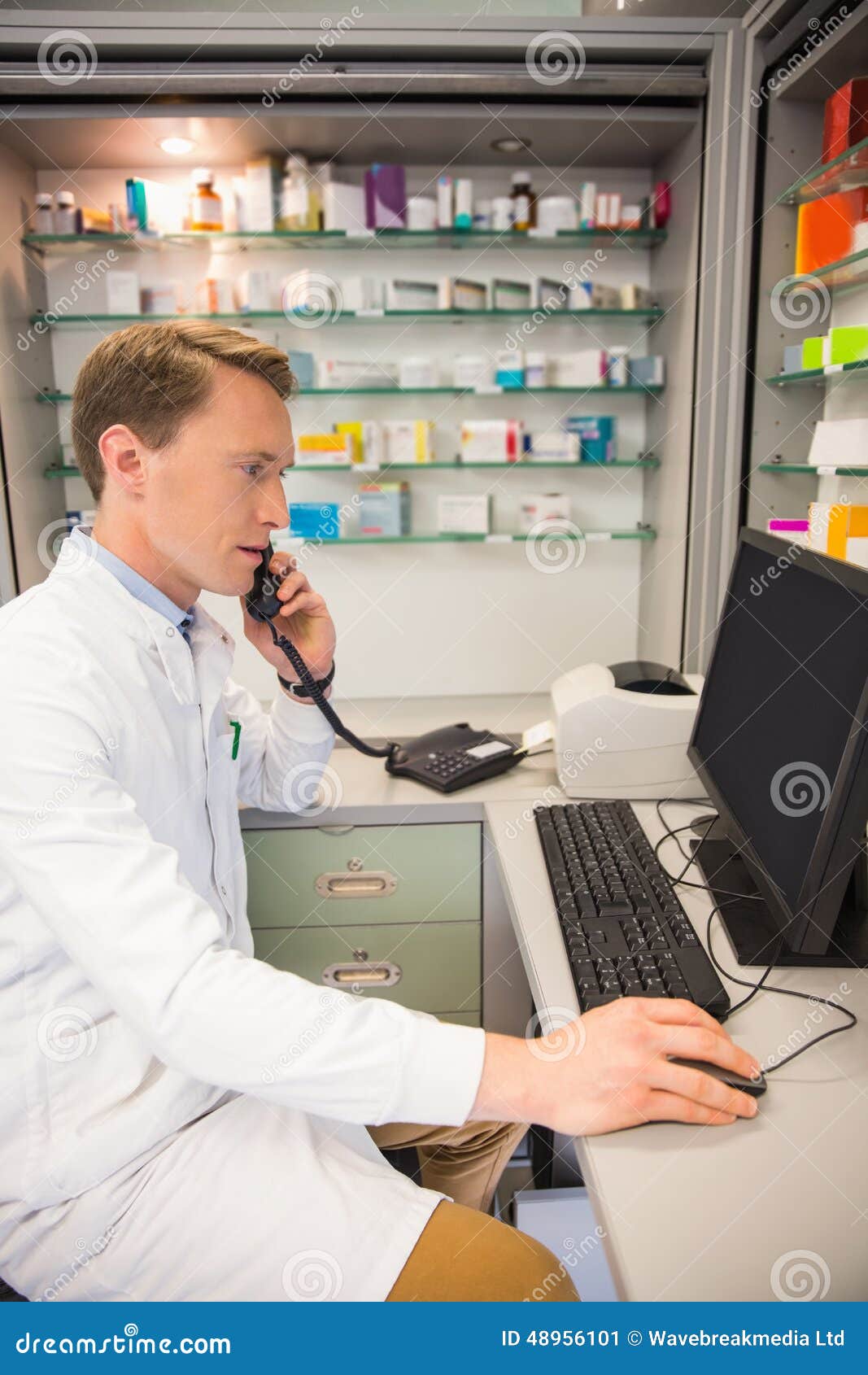 Serious Pharmacist on the Phone Using Computer Stock Image - Image of ...