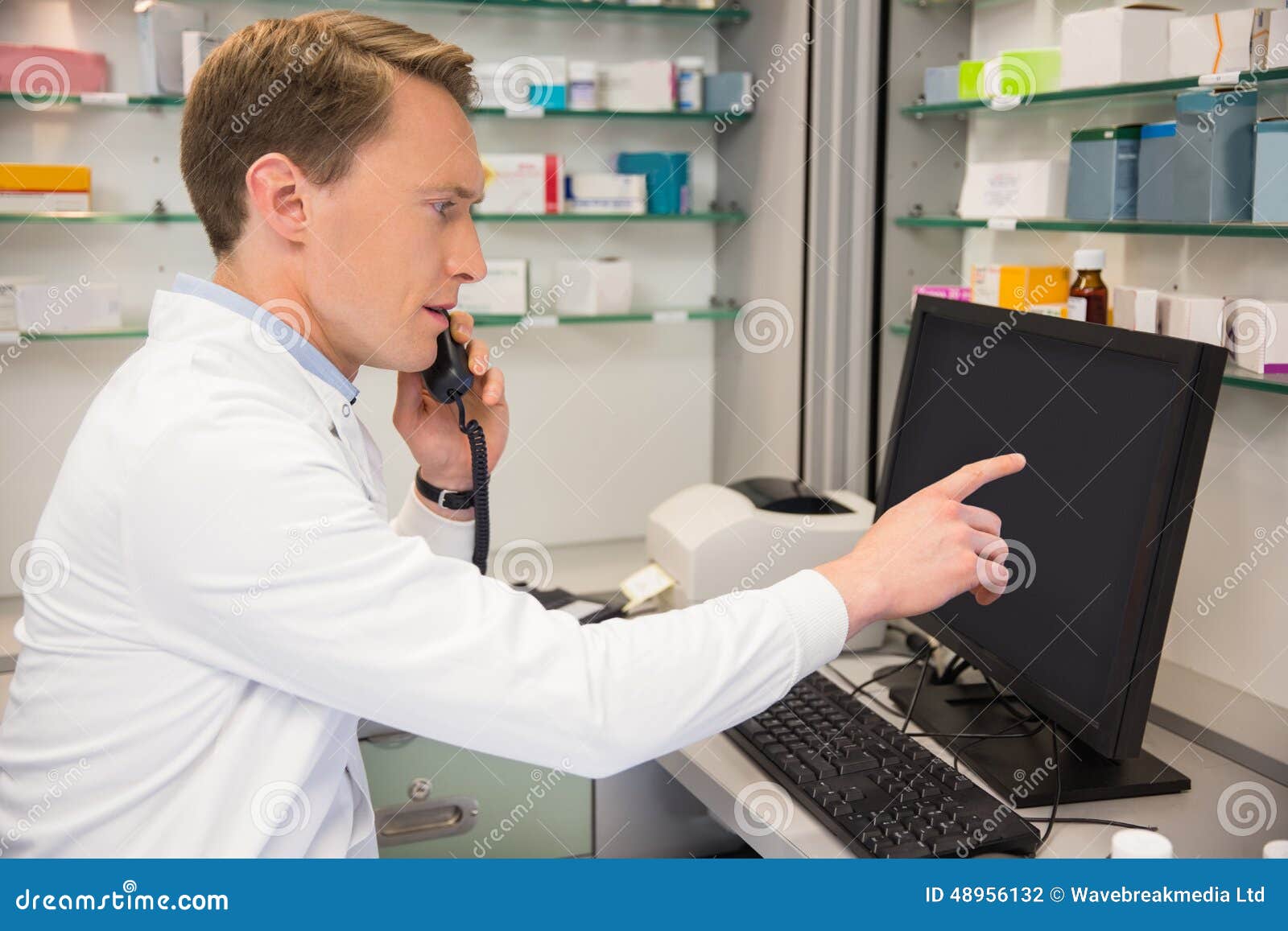 Serious Pharmacist on the Phone Using Computer Stock Photo - Image of ...