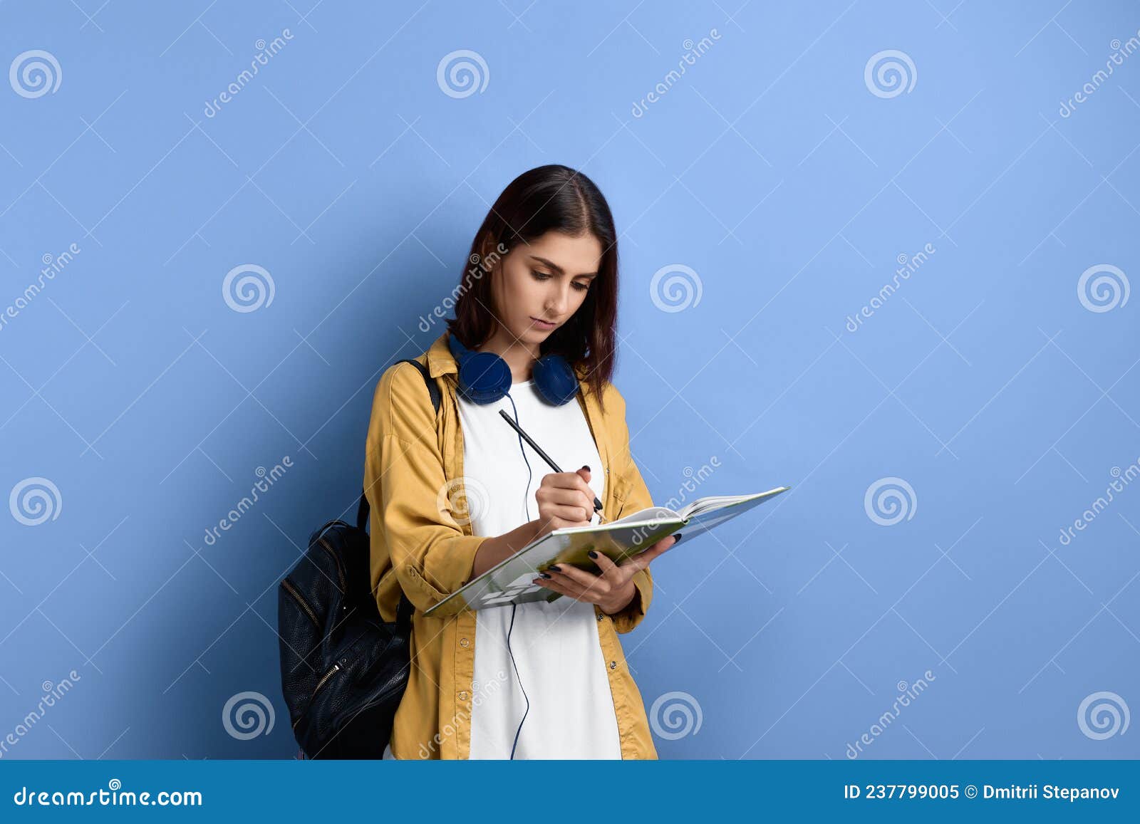 Serious Pretty Student Girl is Making Notes in Book after Classes in ...