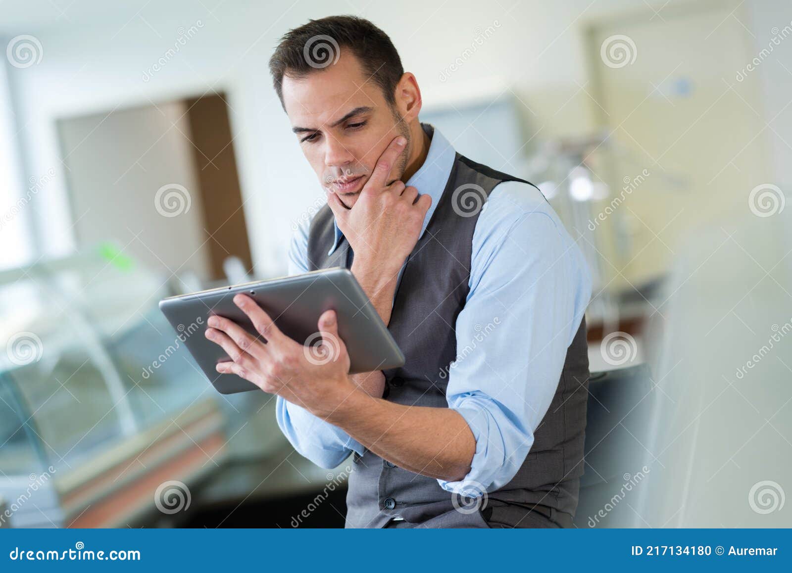 Serious Salesman Looking at Tablet Pc Stock Photo - Image of human ...