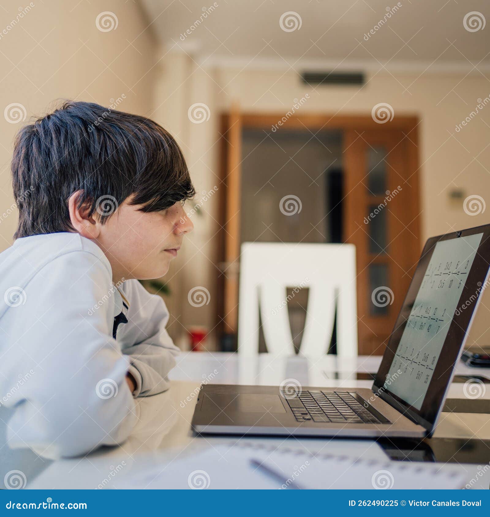 Serious School Boy Concentrated while Studying Maths at Home. Home ...