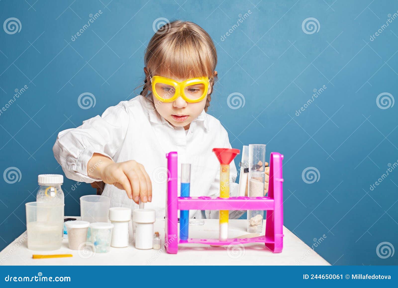 Serious School Girl Doing Science Experiments on Blue Background ...