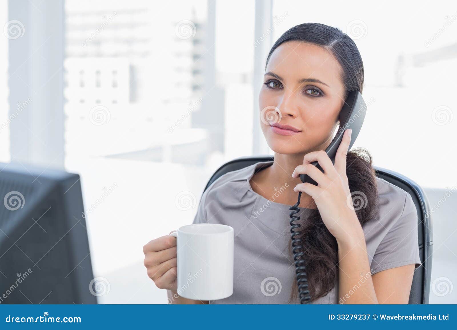 Serious Secretary Answering Phone and Drinking Coffee Stock Image ...