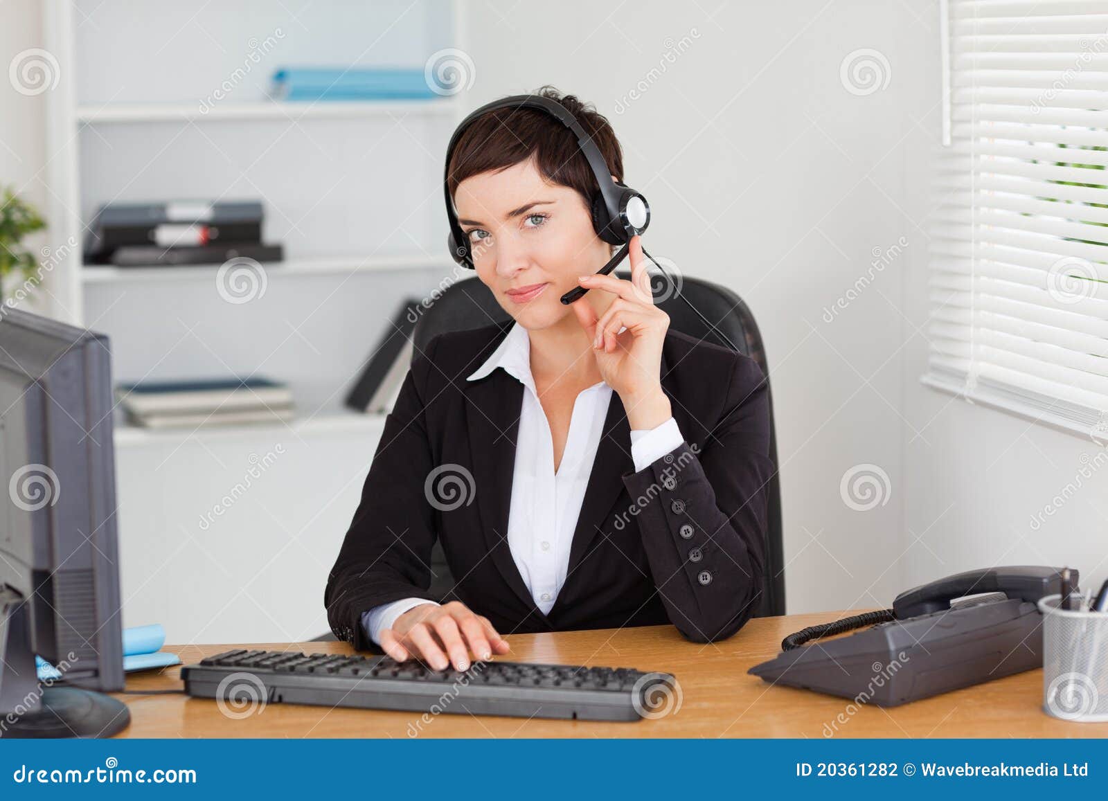 Serious Secretary Calling with a Headset Stock Photo - Image of adult ...