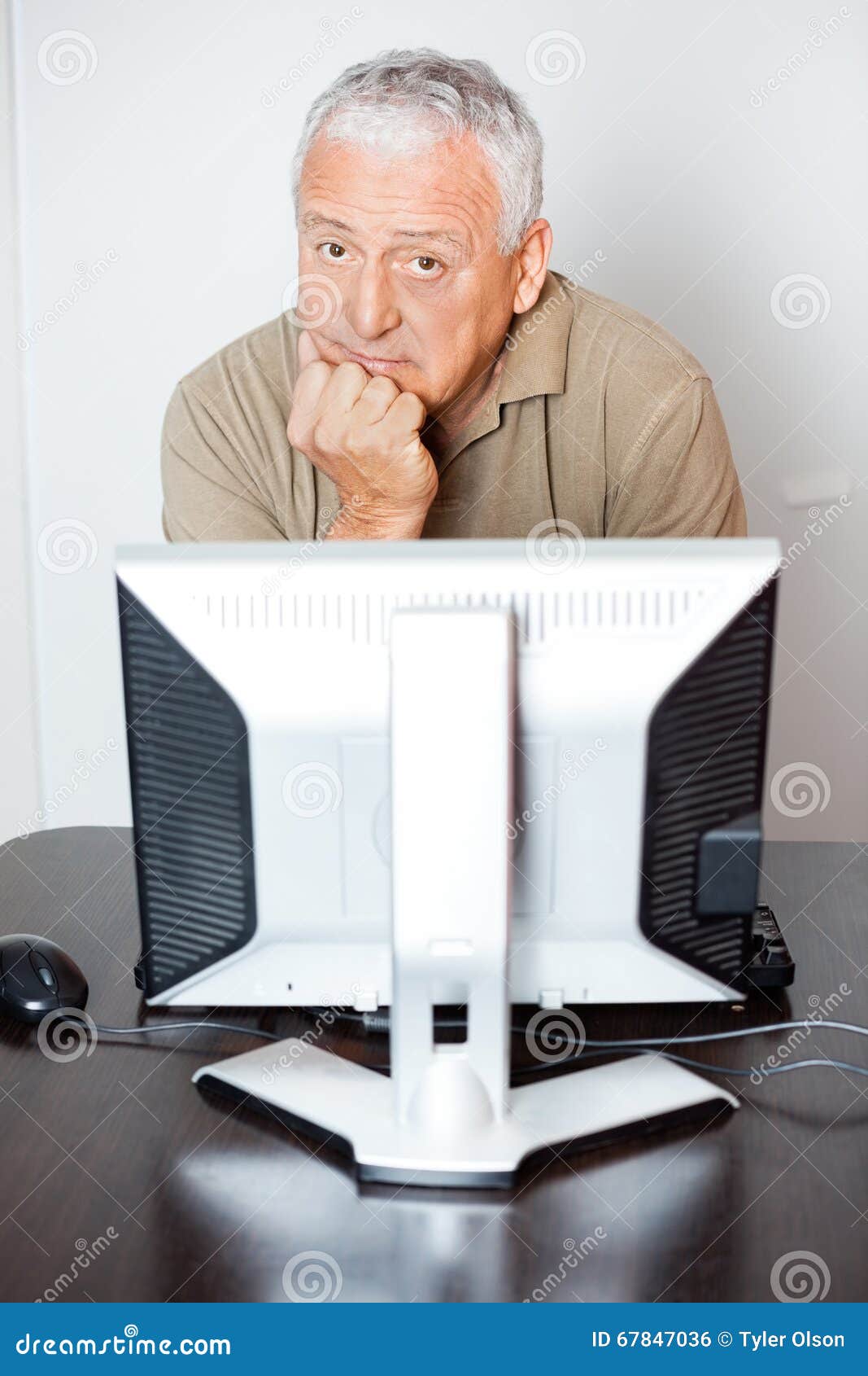 Serious Senior Man Sitting at Computer Desk in Class Stock Photo ...