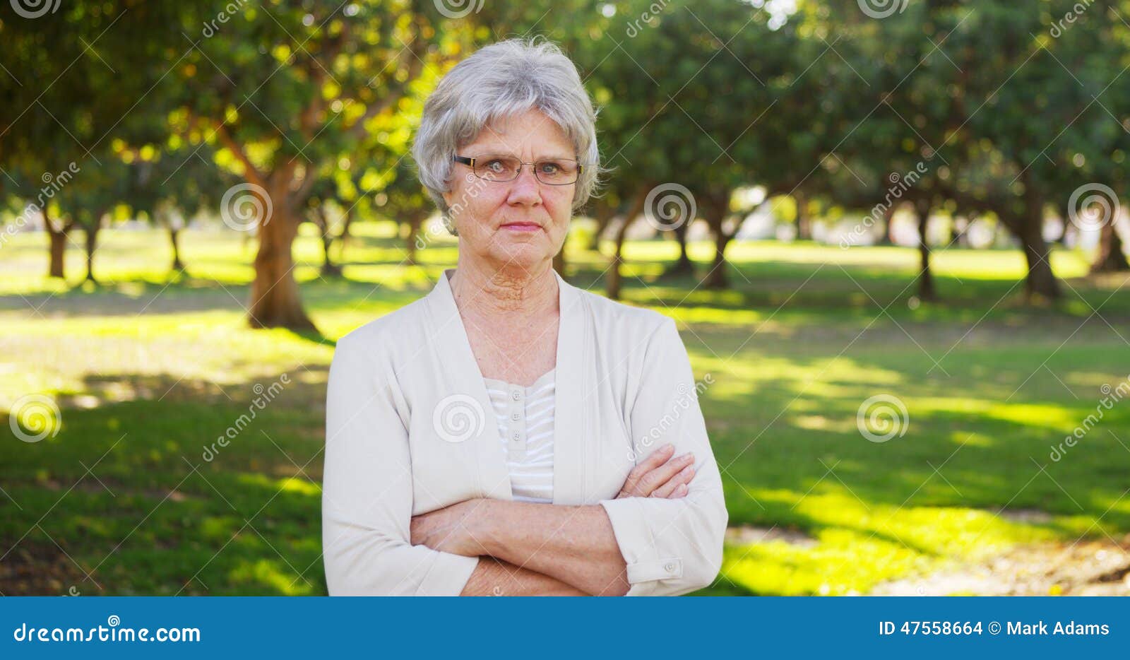 Serious Senior Woman Standing in the Park Stock Photo - Image of ...