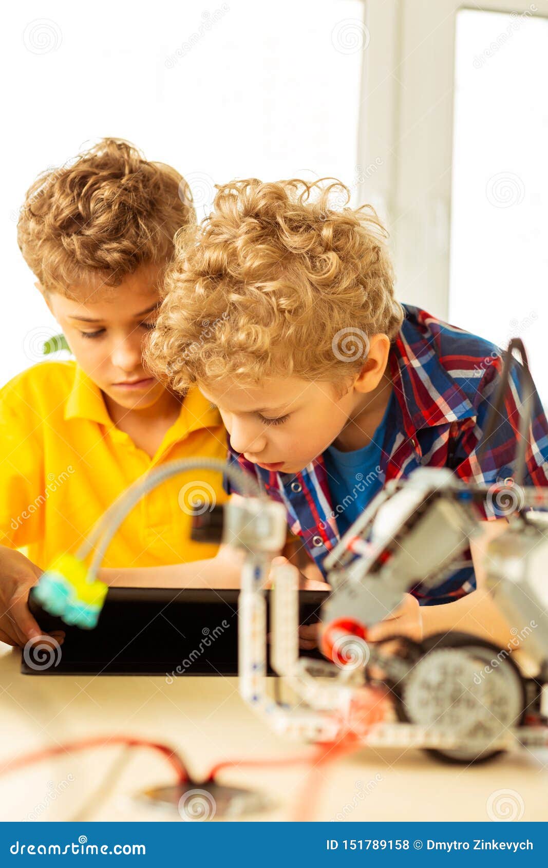 Serious Smart Boys Thinking about the Robot Stock Photo - Image of ...