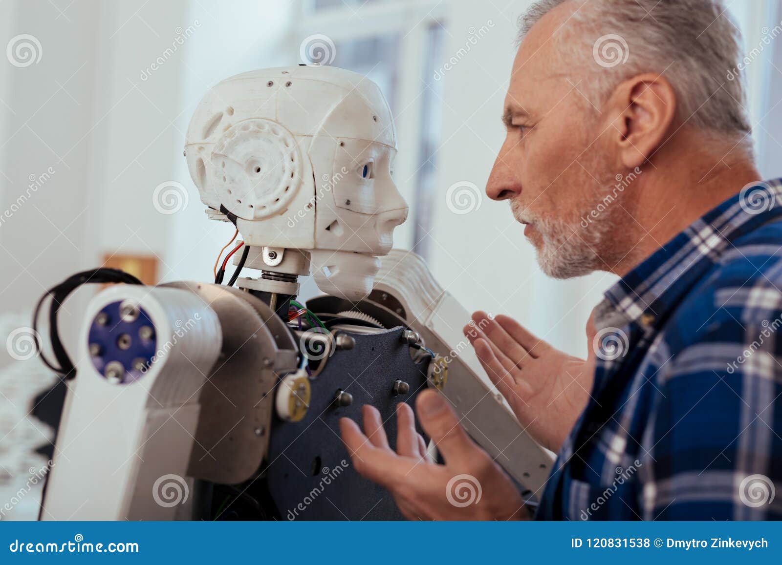 Serious Smart Engineer Looking at the Robot Stock Photo - Image of ...