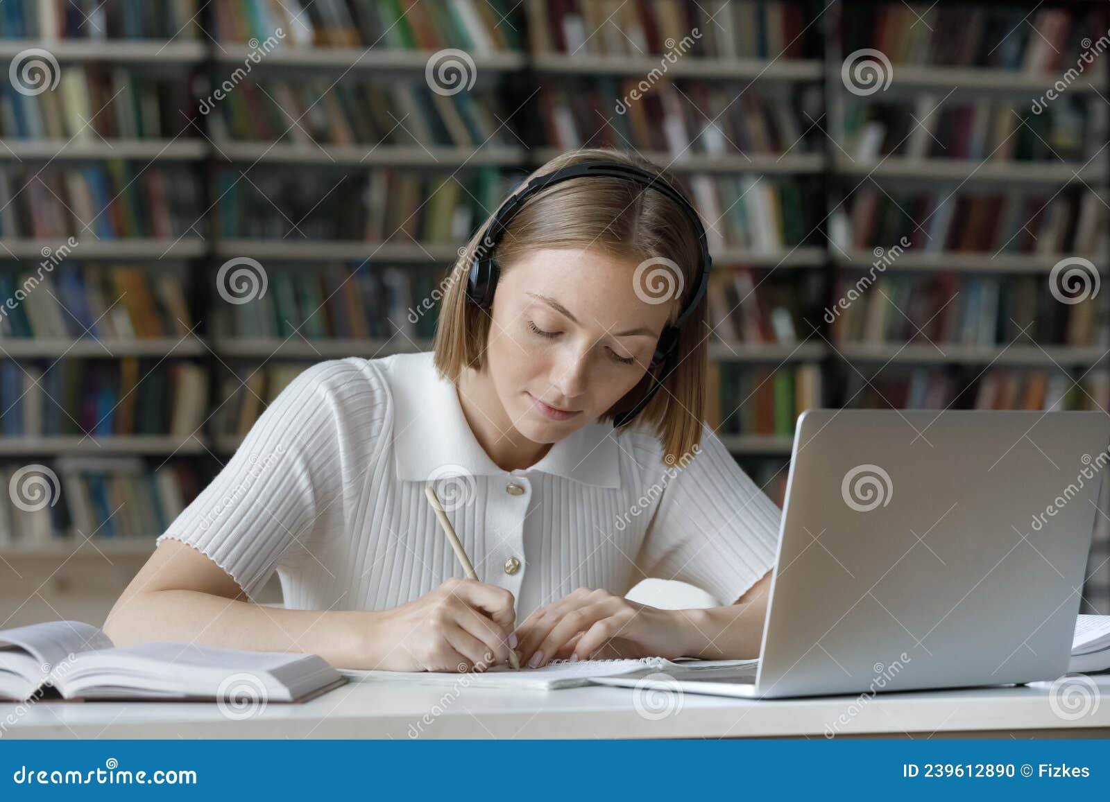 Serious Student Girl Listening To Audio Tutorials from Wireless ...