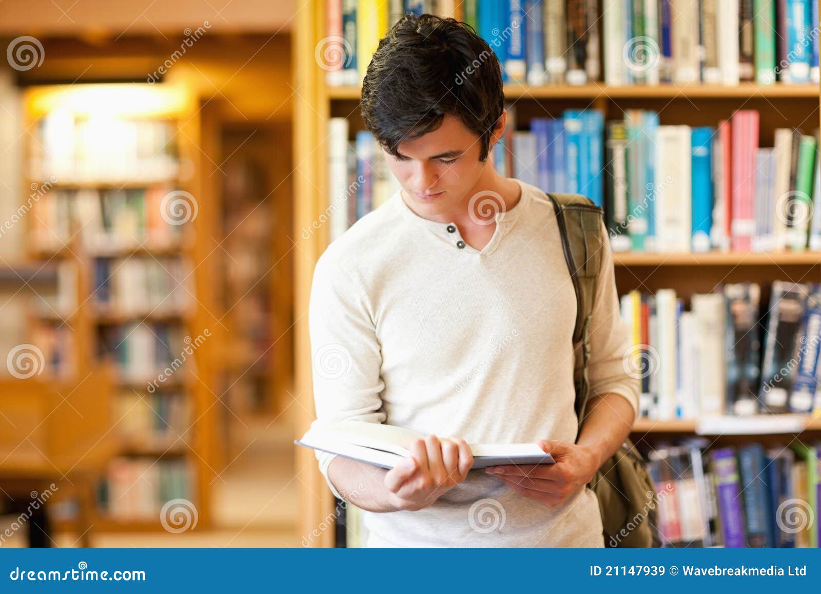 Serious Student Reading a Book Stock Image - Image of holding, indoor ...