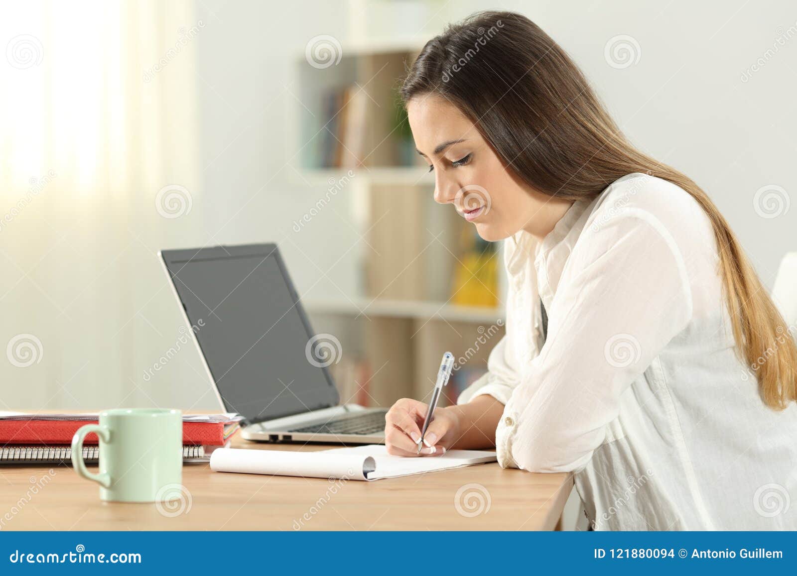 Student Taking Notes in a Notebook on a Table Stock Photo - Image of ...