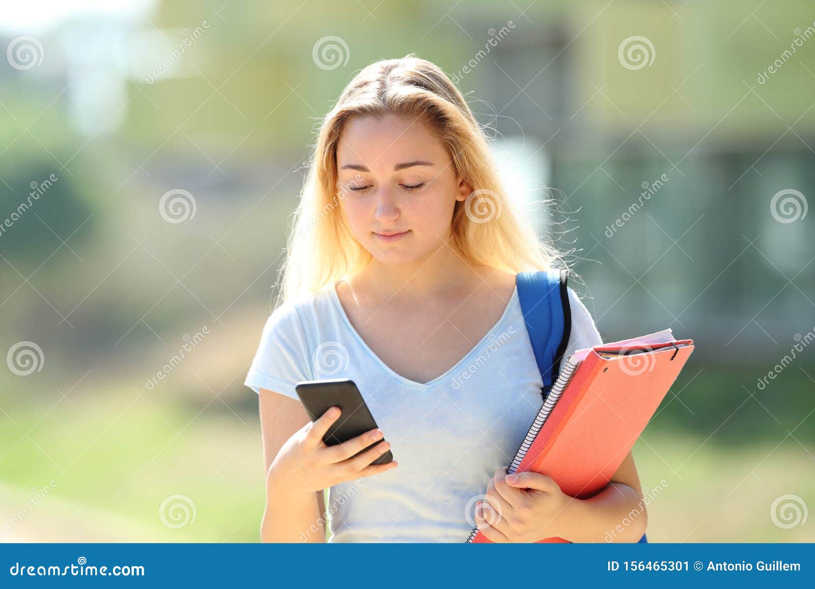 Serious Student Walks Checking Text on Phone Stock Image - Image of ... Serious Student Walks Checking Text on Phone Stock Image - Image of ...