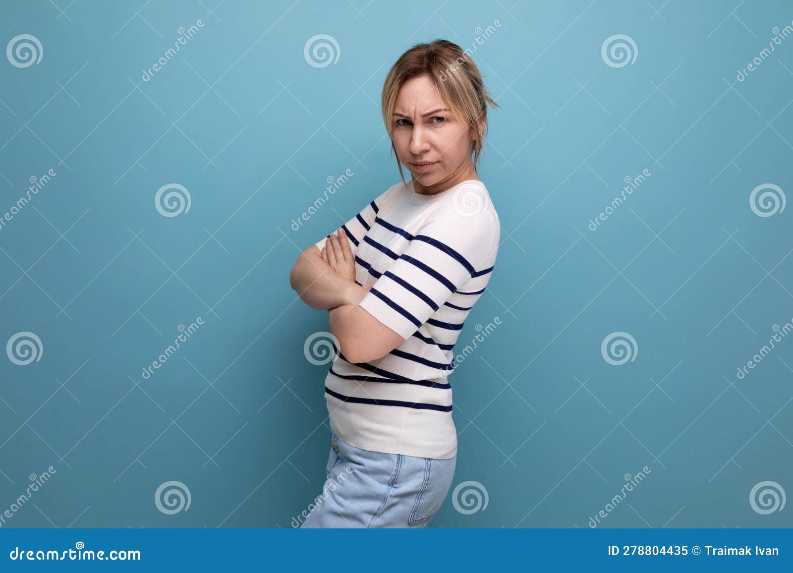 Serious Sullen Blond Girl on a Blue Background with Copyspace Stock ...