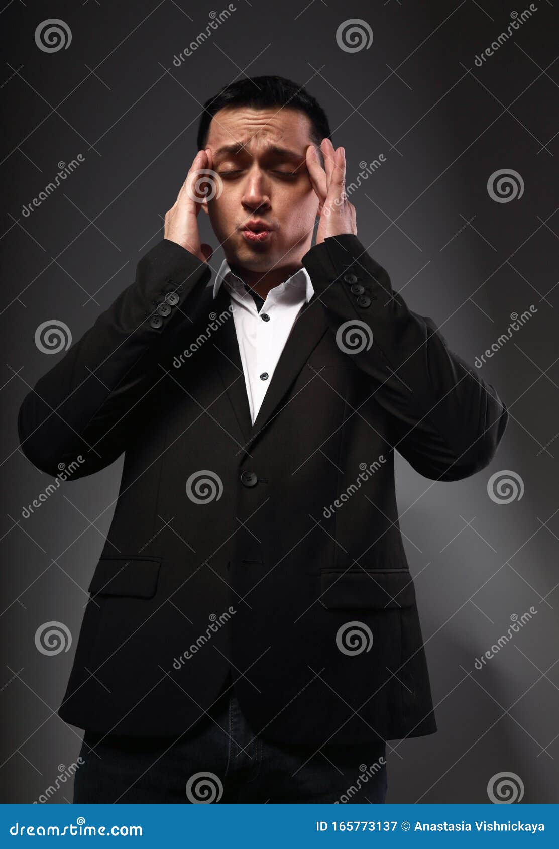 Serious Thinking Man Looking in Black Suit on Grey Studio Background ...