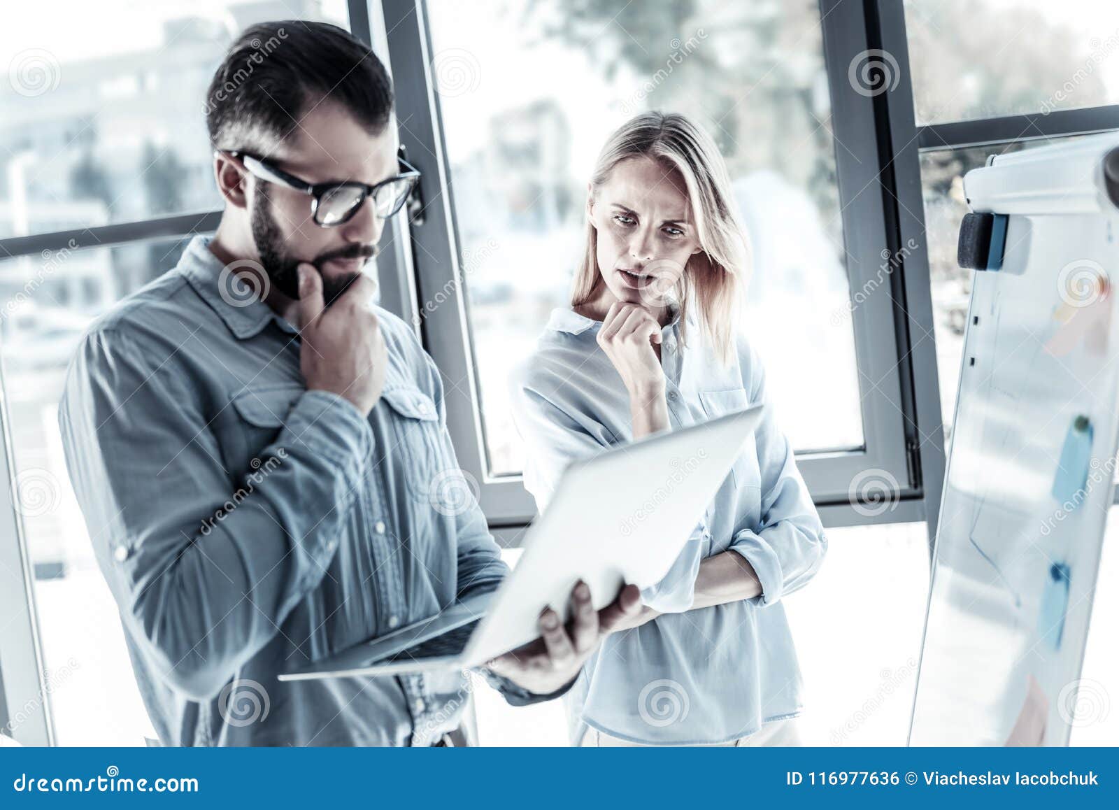 Serious Thoughtful Employees Using the Laptop and Thinking. Stock Photo ...