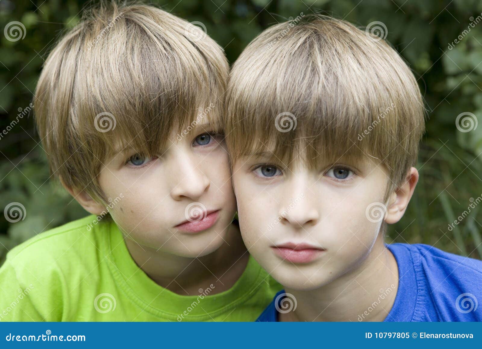 Serious Twins Hugging in Park Stock Image - Image of clasp, cuddling ...