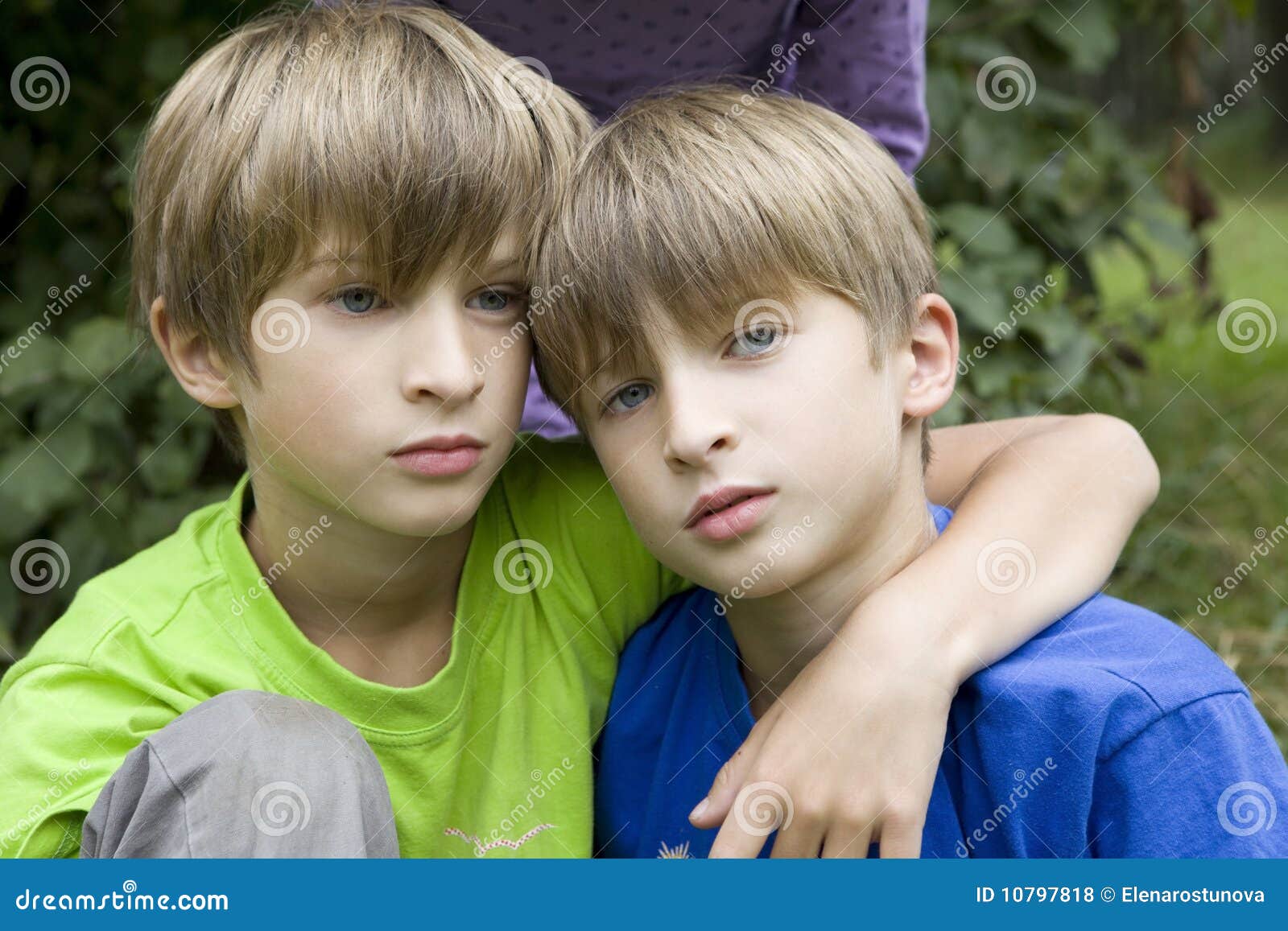 Serious Twins Hugging in Park Stock Photo - Image of outdoors, clasp ...