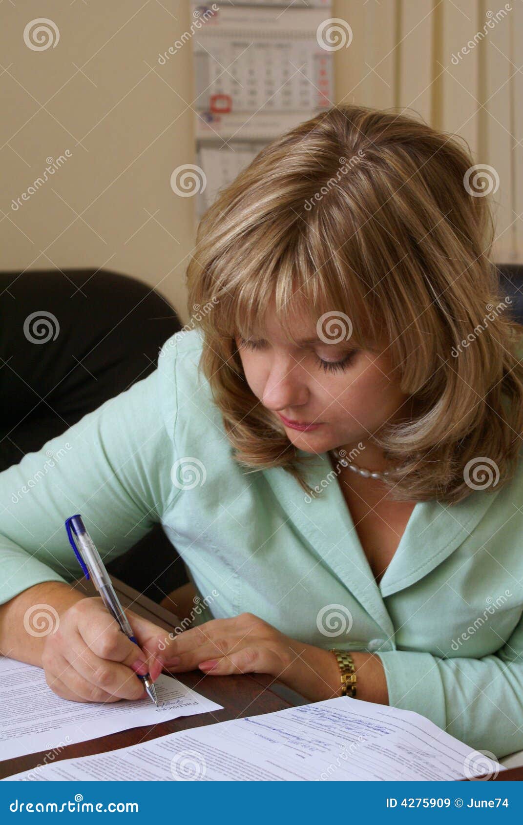 Serious Woman Signing Document Stock Image - Image of office, blond ...