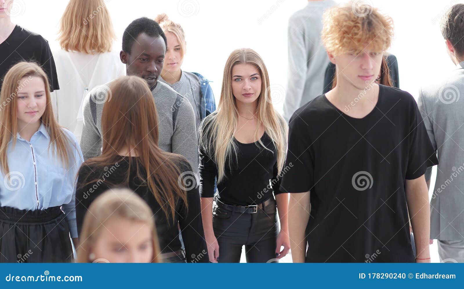 Serious Woman Standing in Front of Casual Group of Young People Stock ...