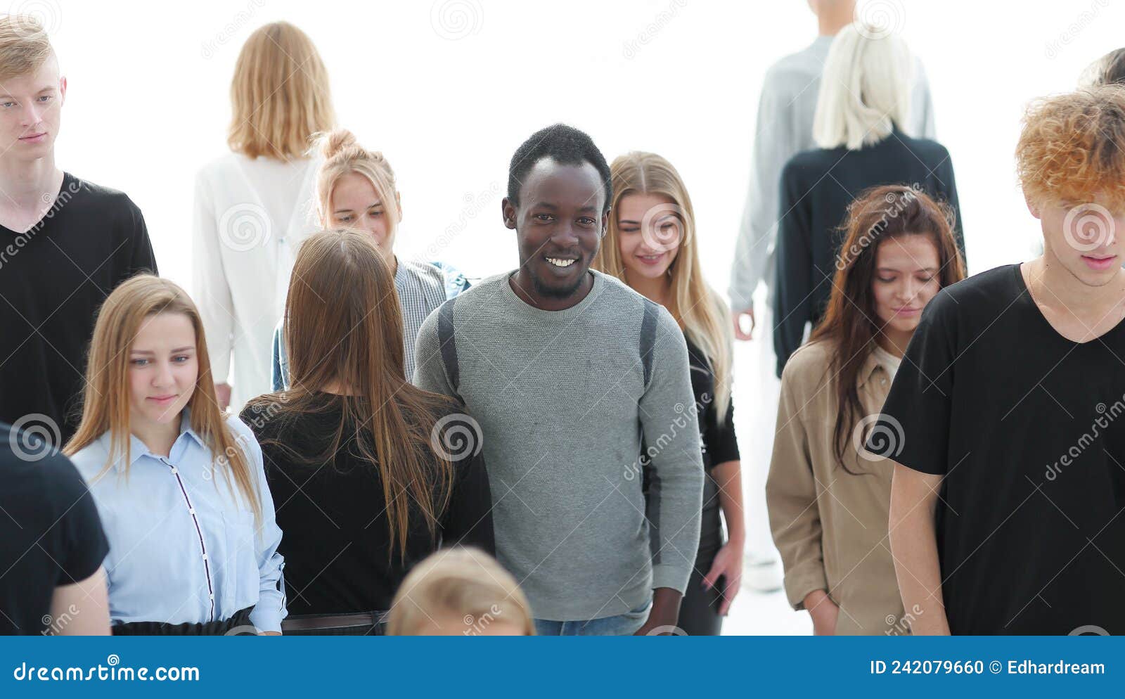 Serious Woman Standing in Front of Casual Group of Young People Stock ...