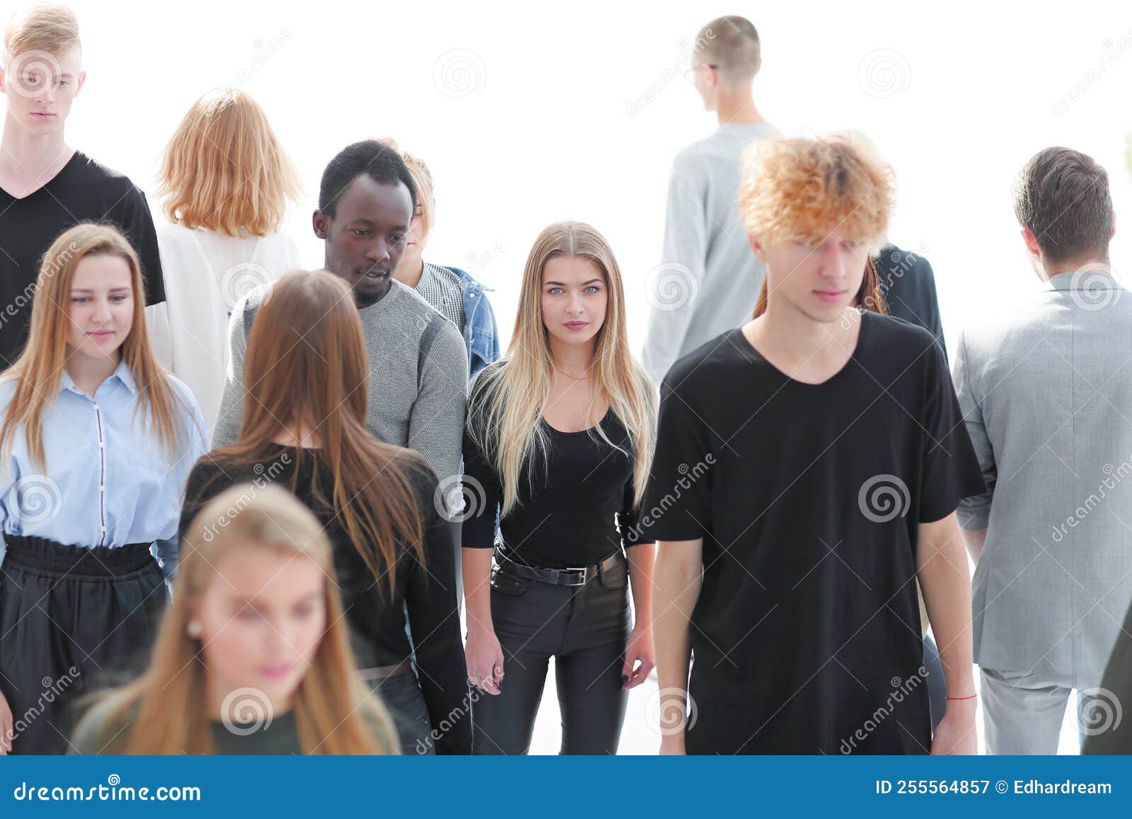 Serious Woman Standing in Front of Casual Group of Young People Stock ...