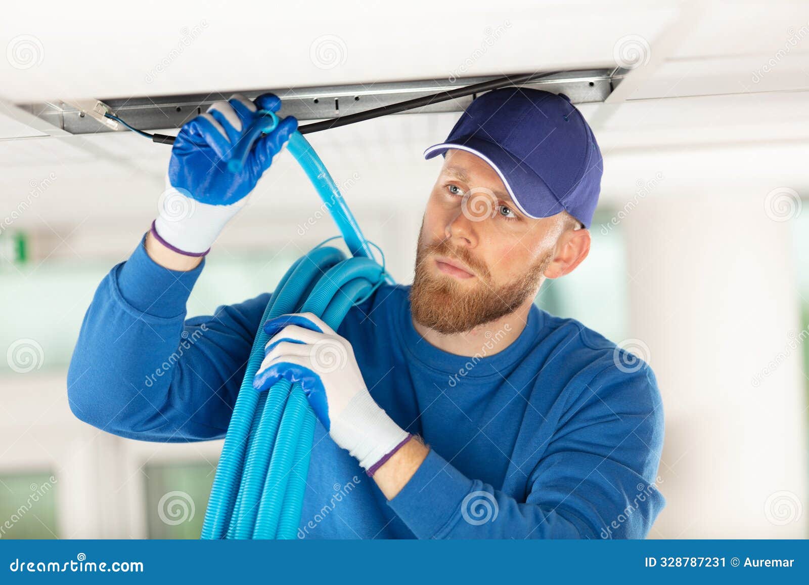 Serious Workman Passing Blue Pipe into Ceiling Stock Image - Image of ...