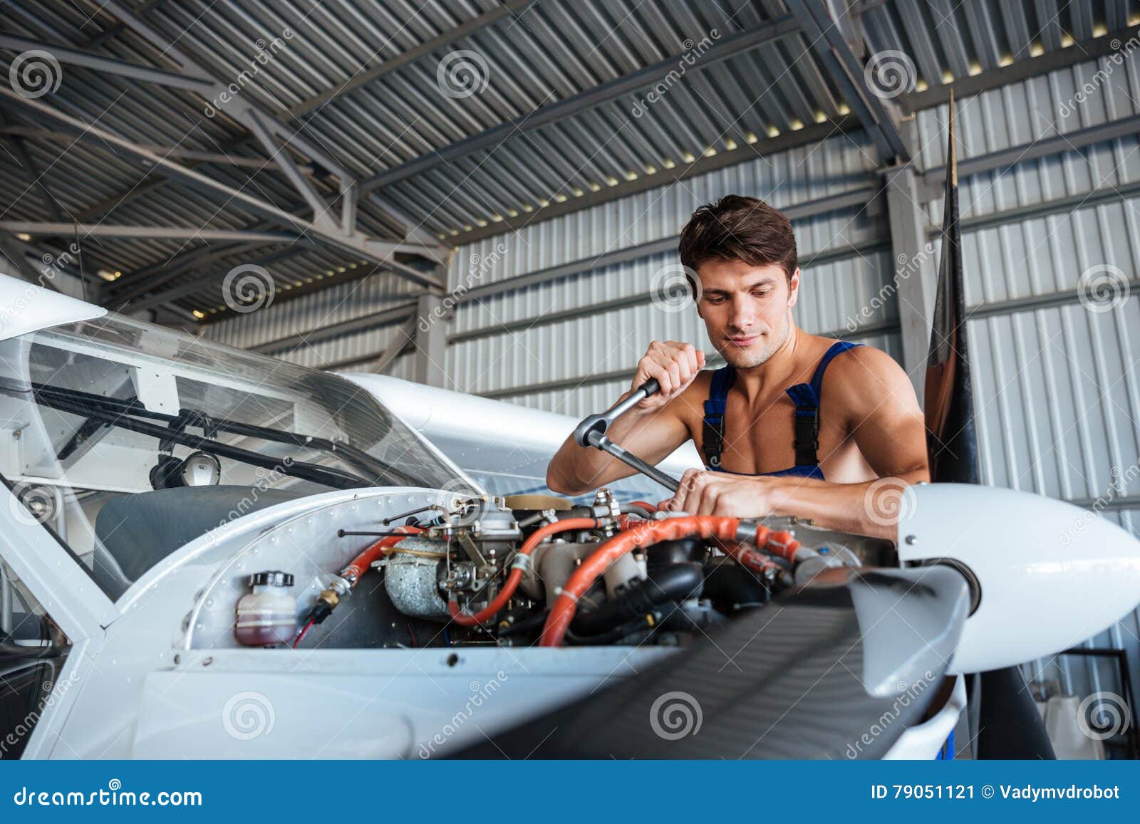 Serious Young Aircraft Mechanic Fixing Small Airplane Stock Image ...