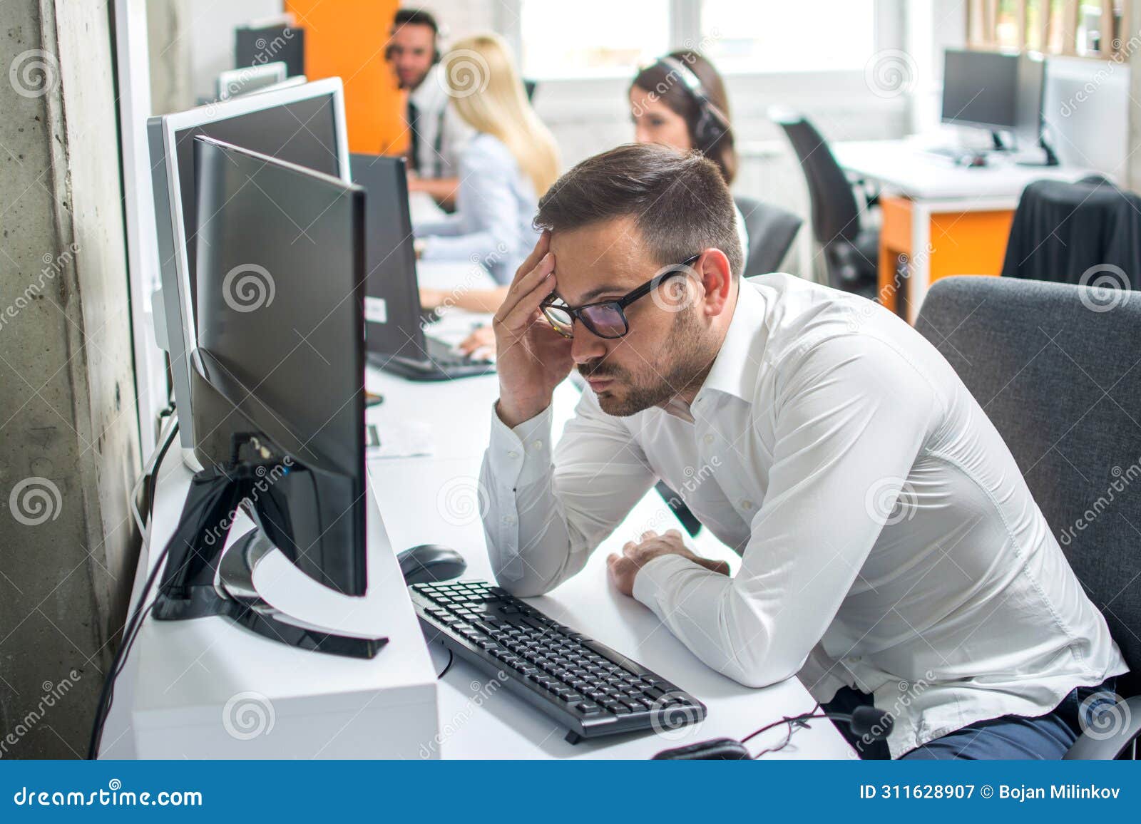 Serious Young Beard Man Looking at Computer Screen while Sitting at His ...