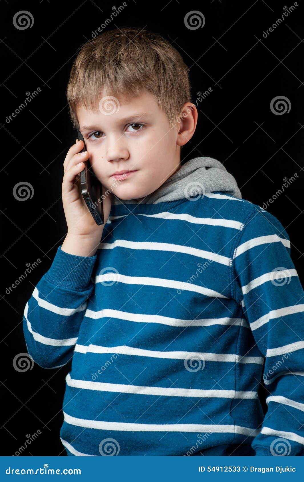 Serious Young Boy Talking on Mobile Phone Stock Image - Image of hands ...