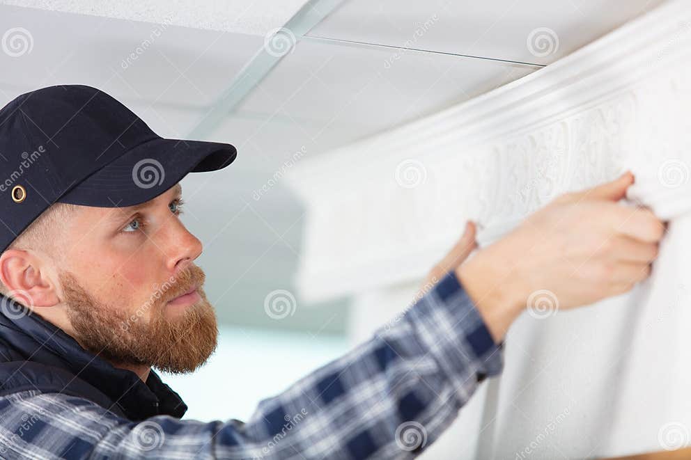 Serious Young Builder Working on Wall Cornicing Stock Photo - Image of ...