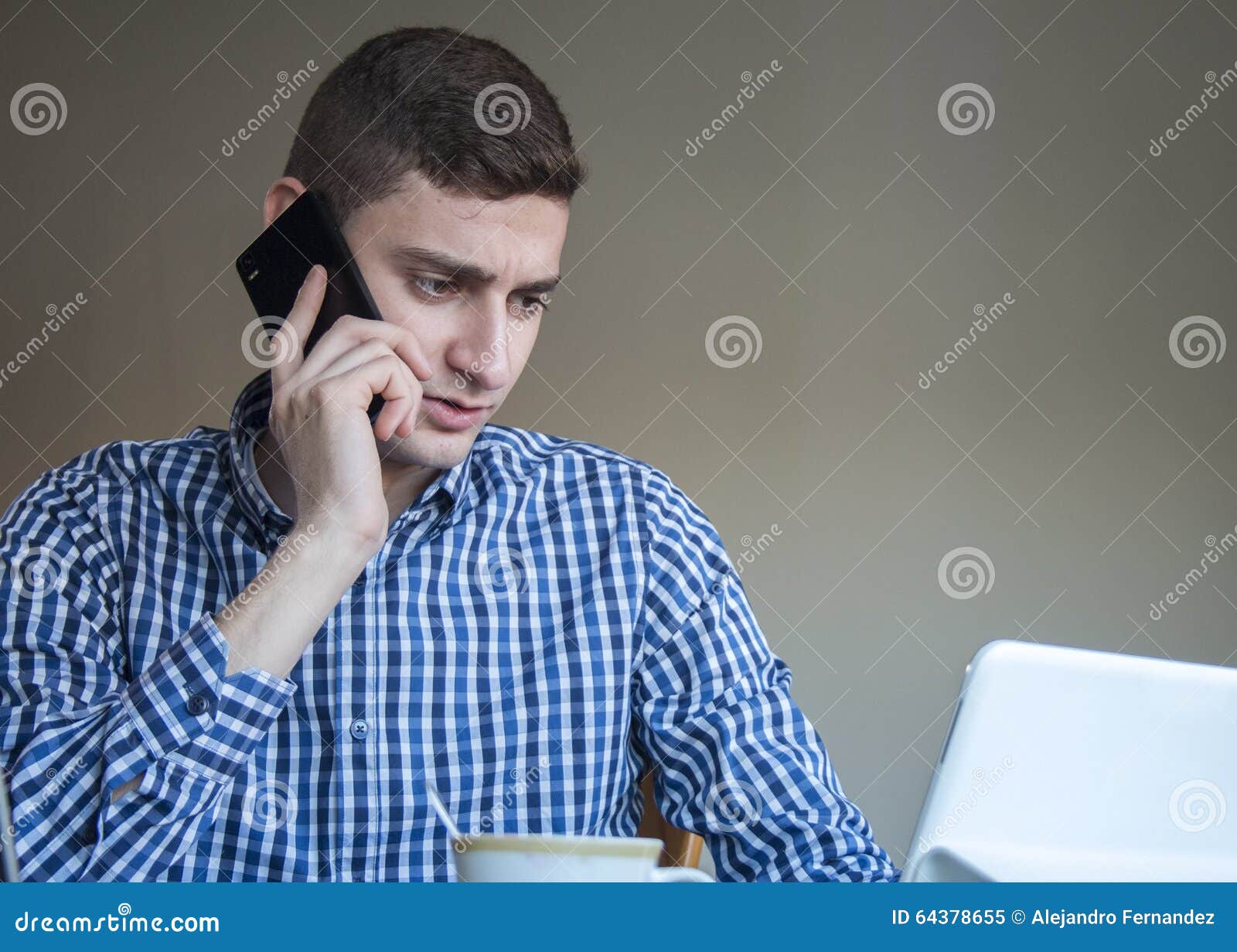 Serious Young Business Man Speaking on Phone, Checking Data on Screen ...