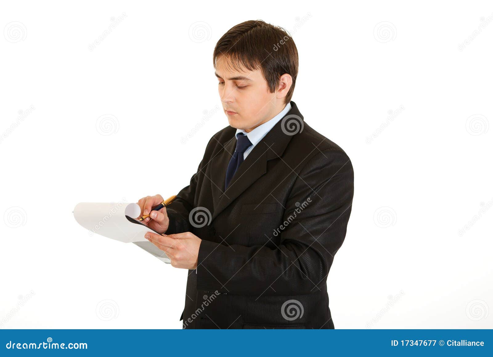 Serious Young Businessman Making Notes in Document Stock Image - Image ...