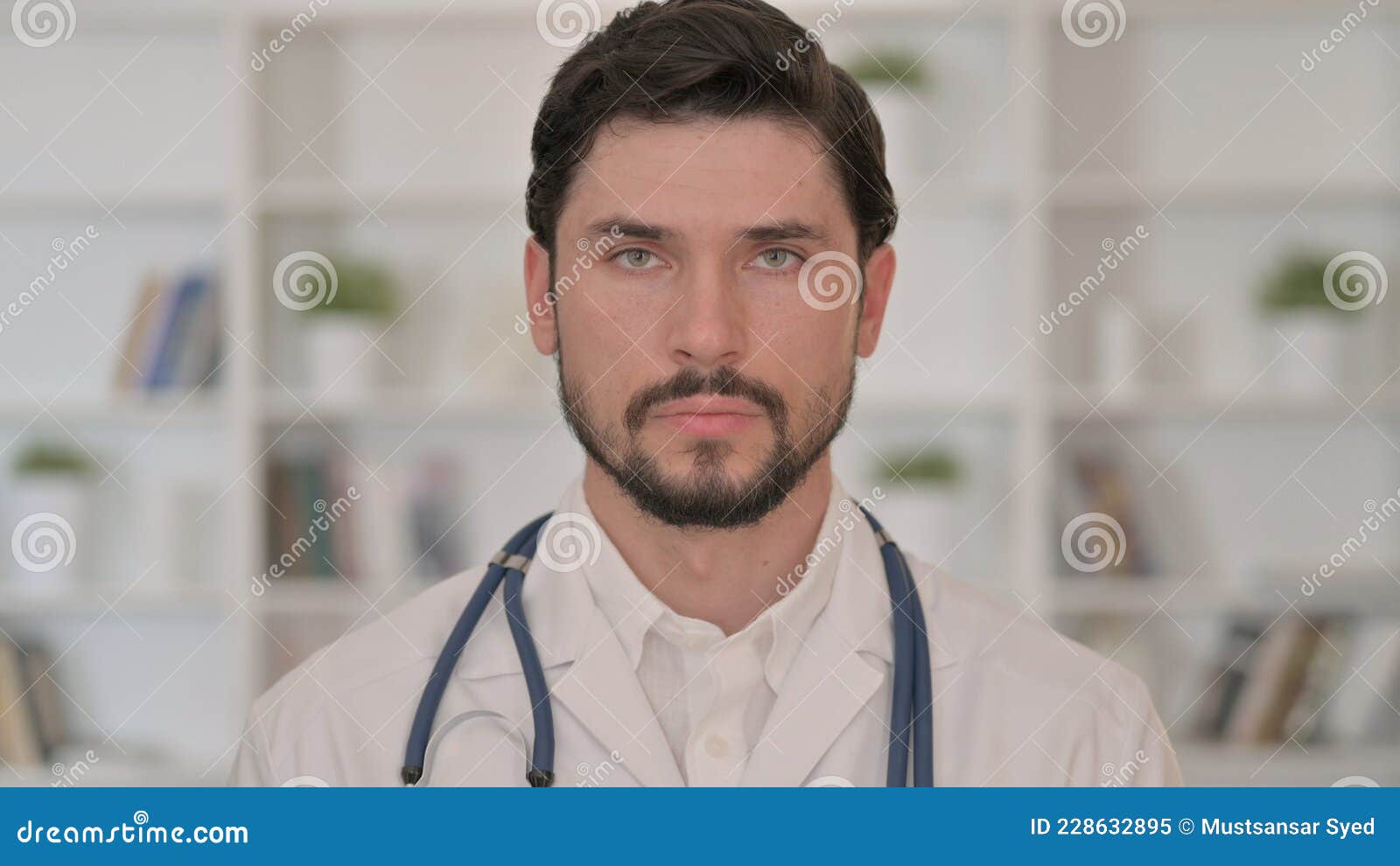Serious Young Doctor Looking at the Camera Stock Image - Image of ...