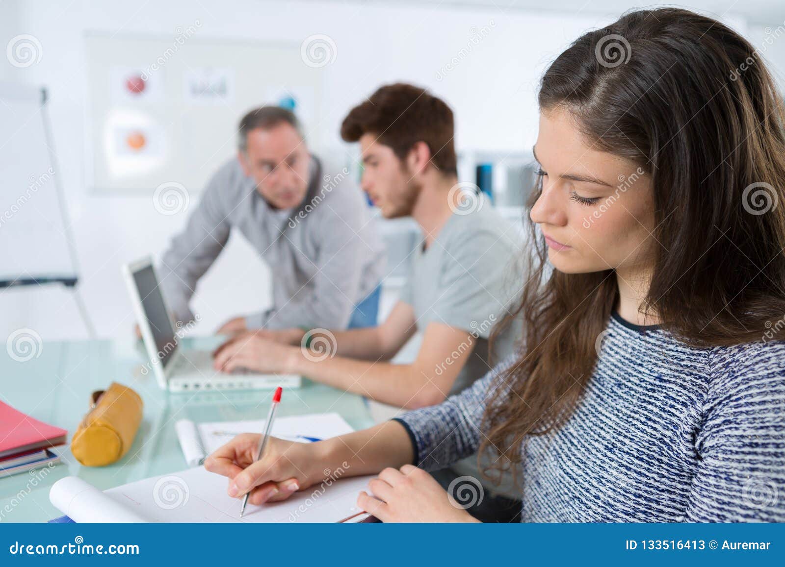 Serious Young Female Student Taking Notes in Class Stock Image - Image ...