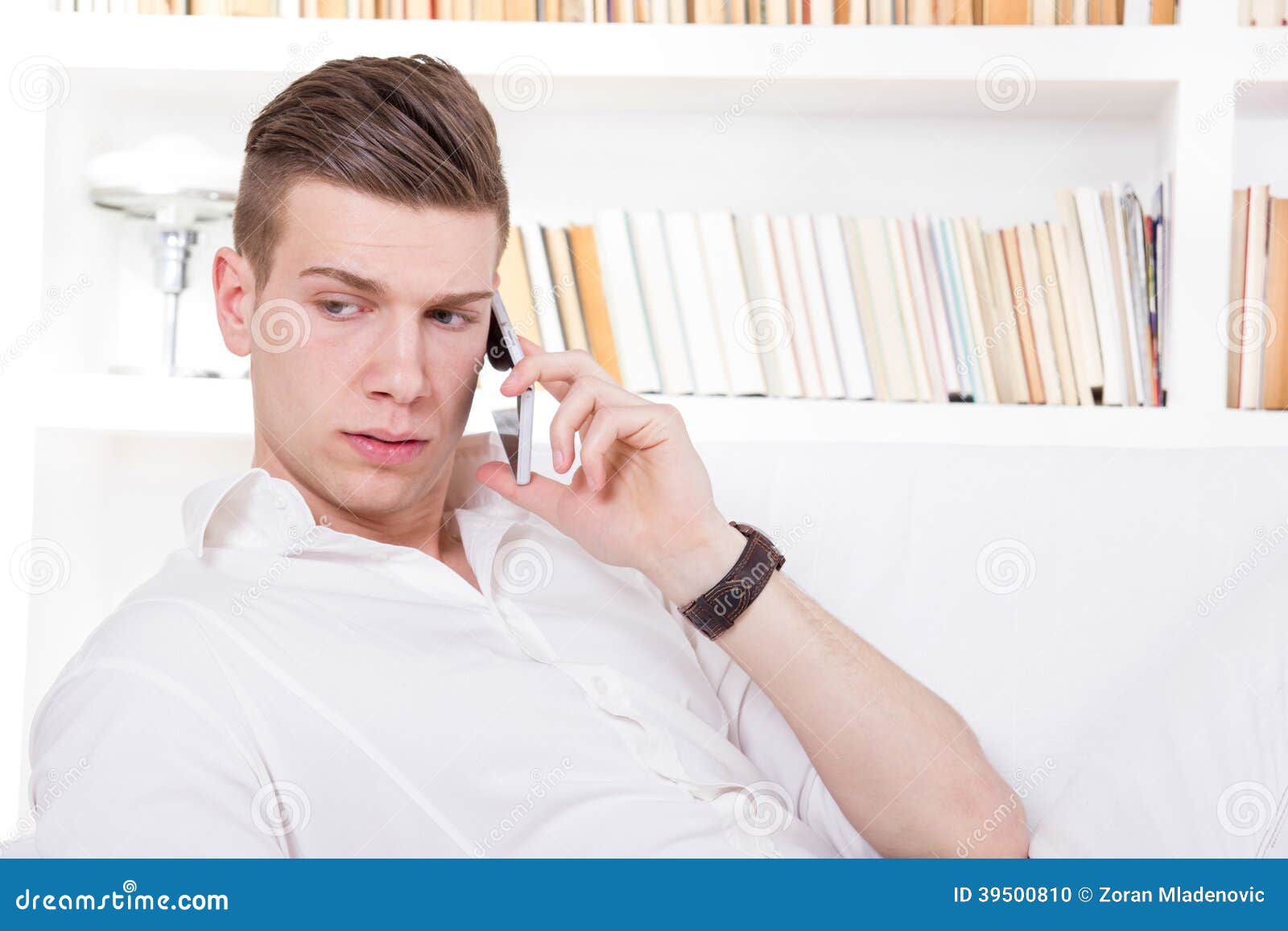 Serious Young Guy in White Shirt Talking on the Cellphone Stock Photo ...