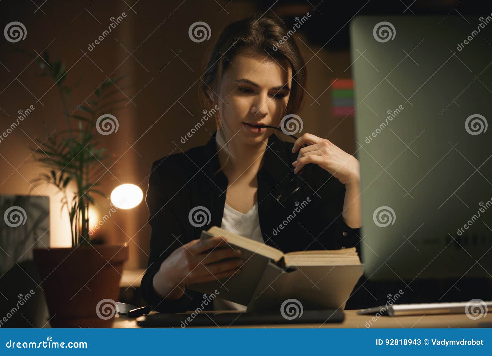 Serious Young Lady Designer Reading Book. Looking Aside. Stock Image ...