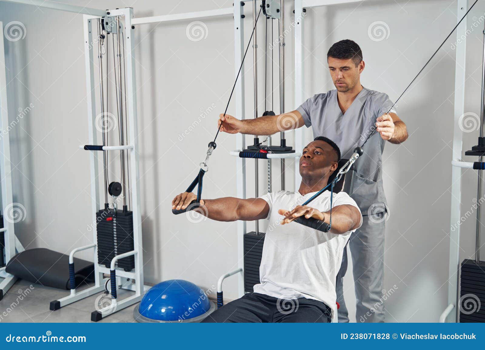 Focused Guy Pulling Down Cable Machine Handles with Both Hands Stock ...
