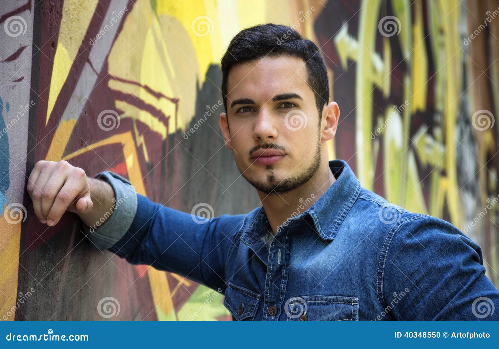Serious Young Man Leaning on Colorful Graffiti Wall Stock Photo - Image ...