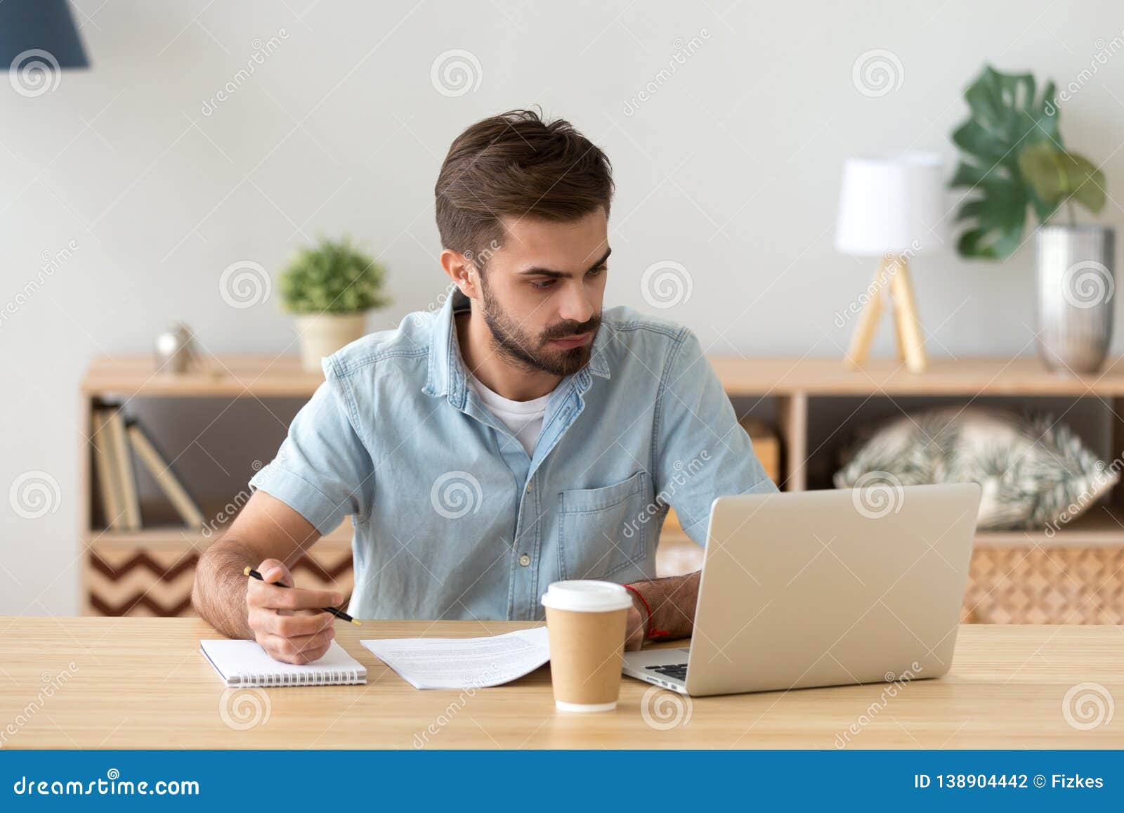 Serious Man Looking at Laptop Making Notes Working with Documents Stock ...