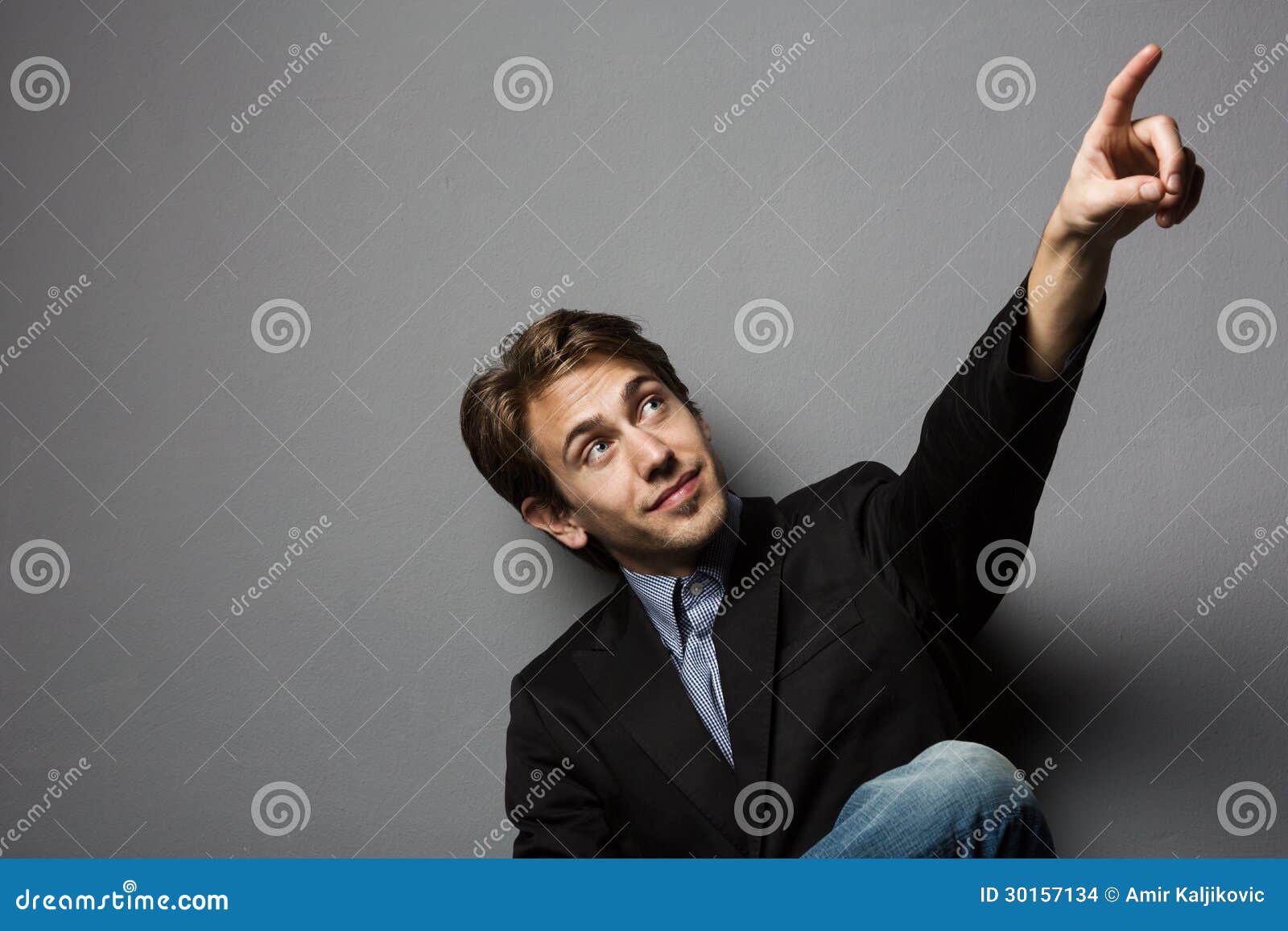Young man pointing upwards stock photo. Image of dark - 30157134