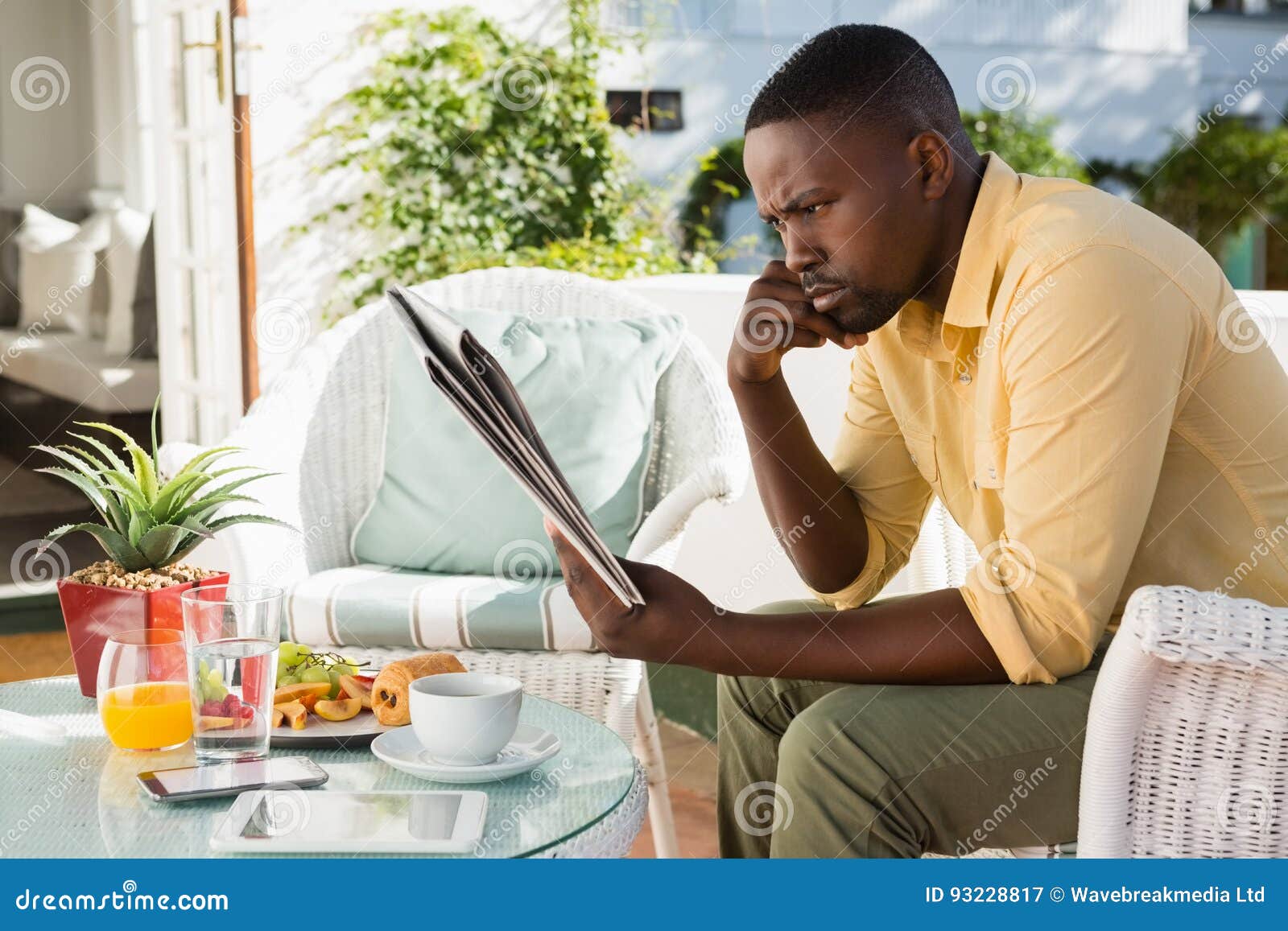Serious Young Man Reading Newspaper by Breakfast Table Stock Image ...