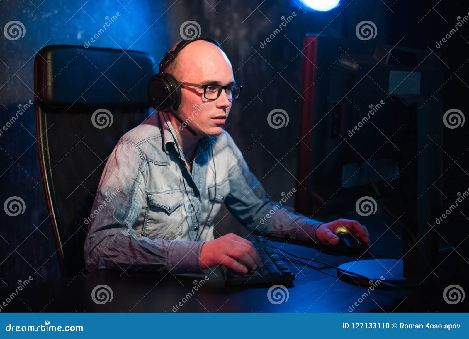 Serious Young Man Sitting and Working with Computer in Dark Office ...
