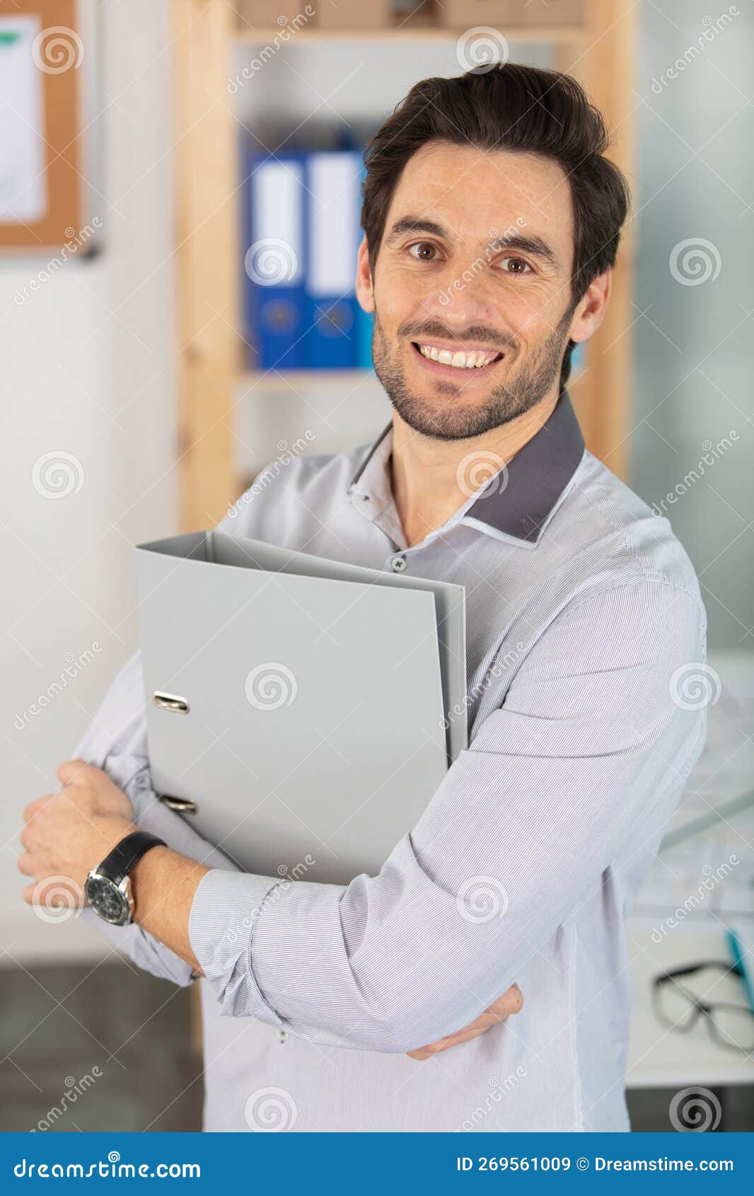 Serious Young Man Standing with Binder Stock Image - Image of portrait ...